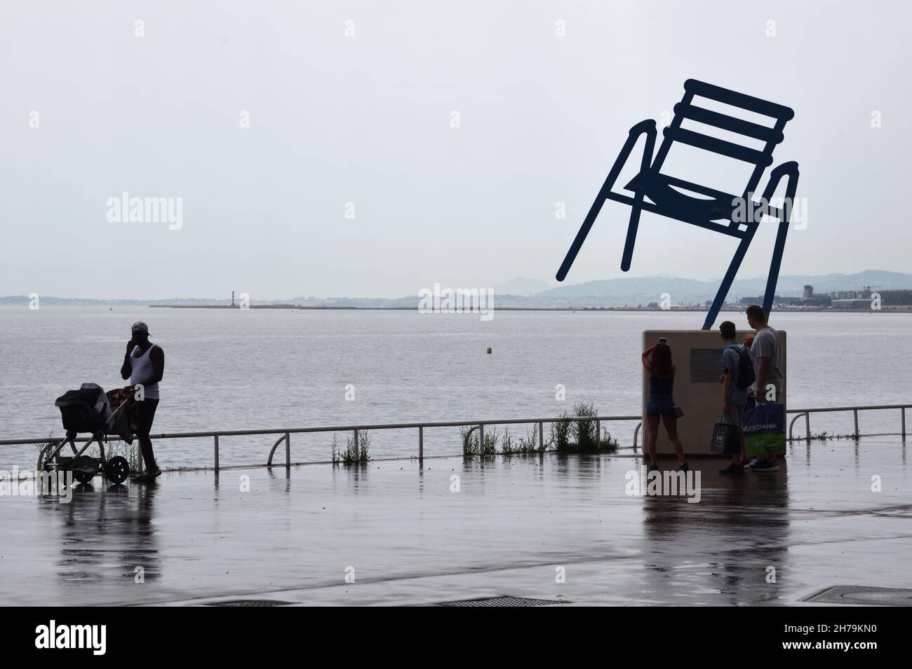 Rainy Day on the Promenade des Anglais with Man Pushing Stroller or ...