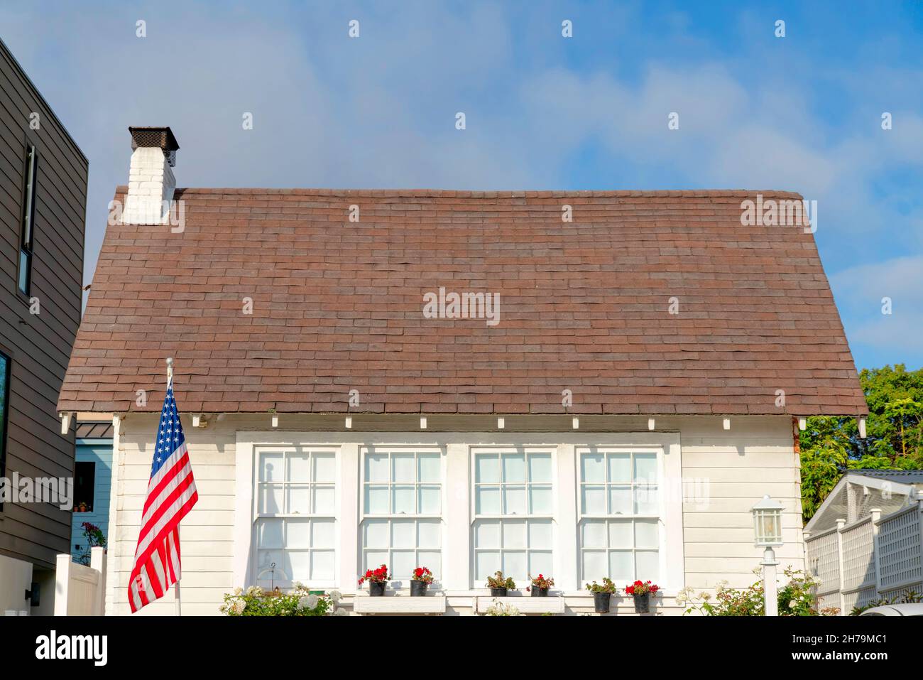 Small traditional gable house with USA flag at the front in La Jolla ...