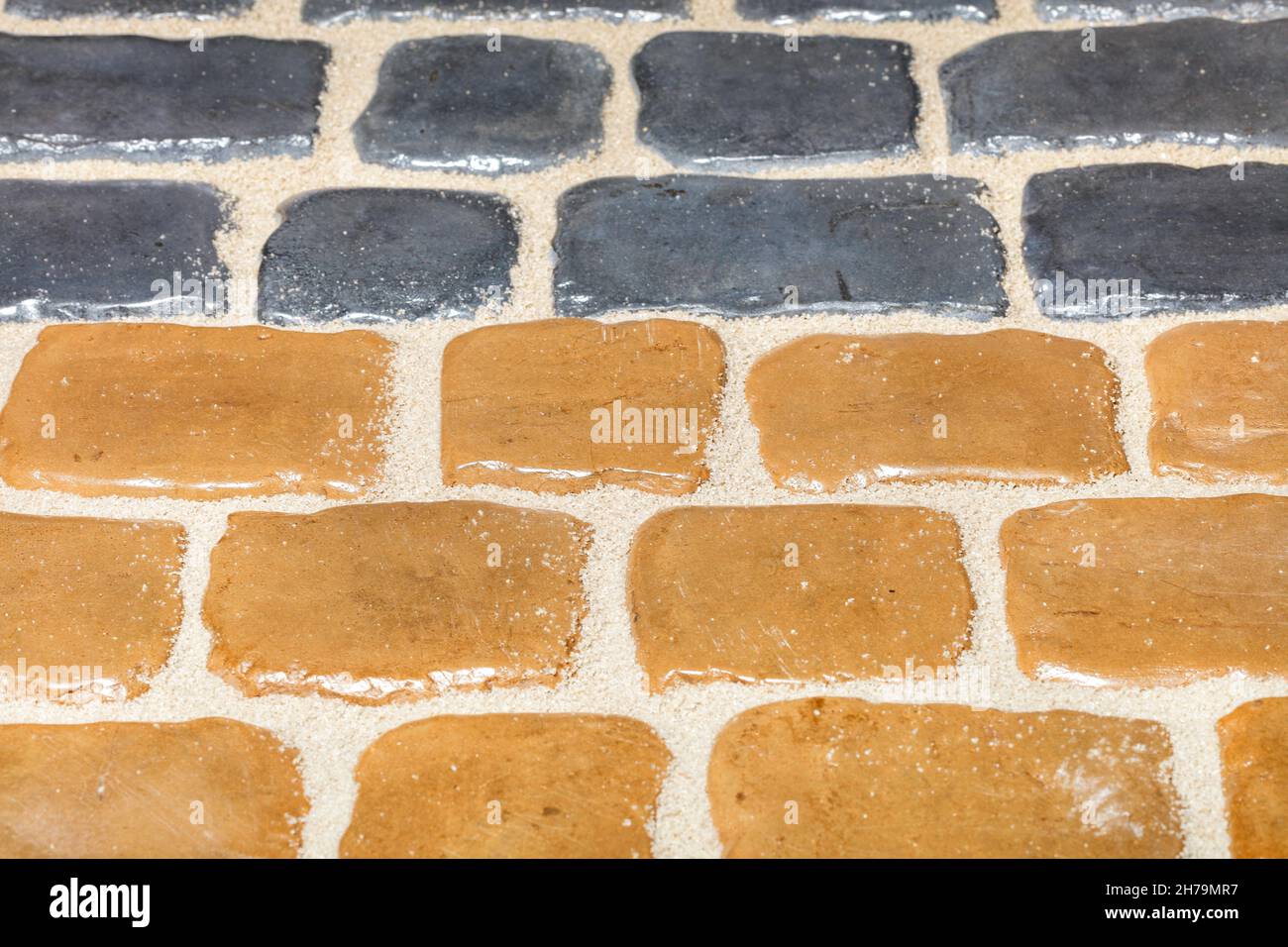 The texture of a fragment of a colored pavement of yellow and gray ...