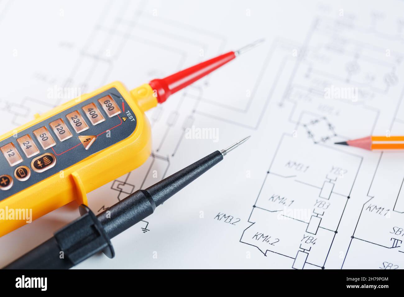 The two-pole voltage indicator lies on the electrical drawing. Testing ...