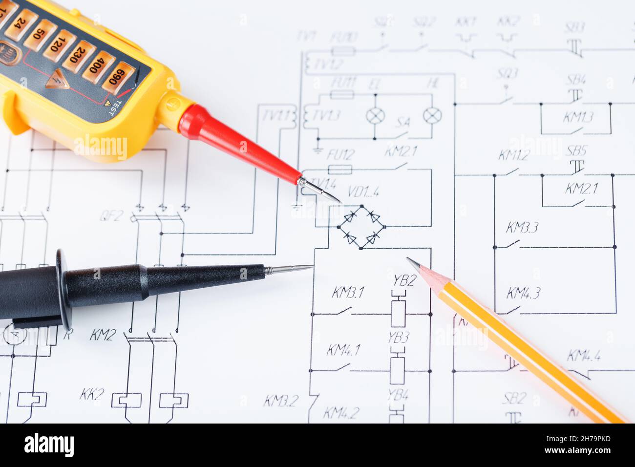 The two-pole voltage indicator lies on the electrical drawing. Testing ...