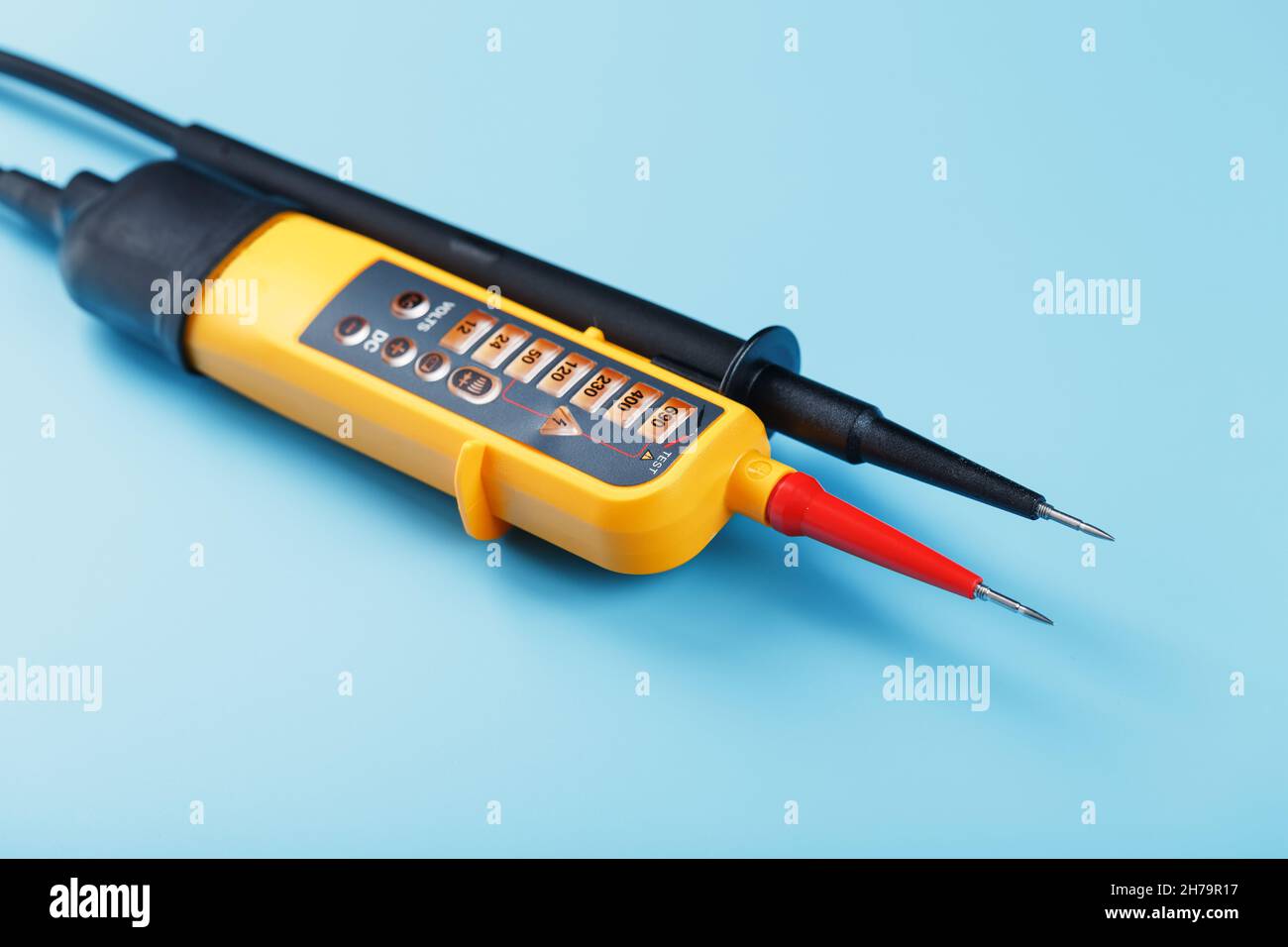 Two-pole voltage indicator close-up on a blue background. Testing and ...