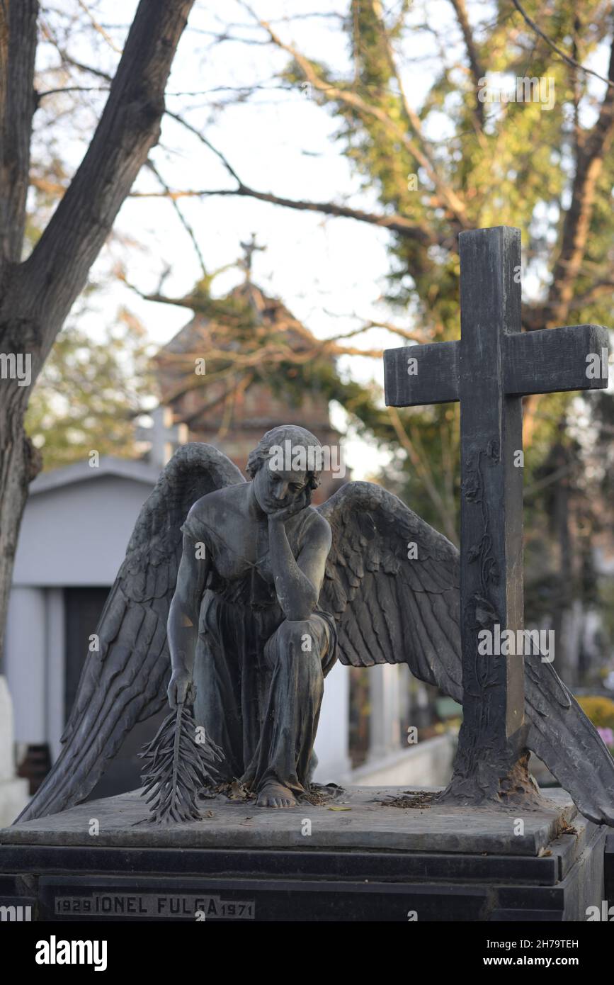 sad angel near cross Stock Photo - Alamy