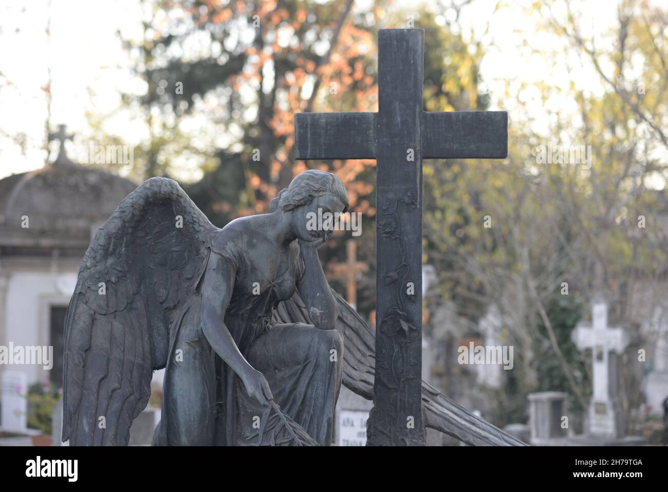 sad angel near cross Stock Photo - Alamy