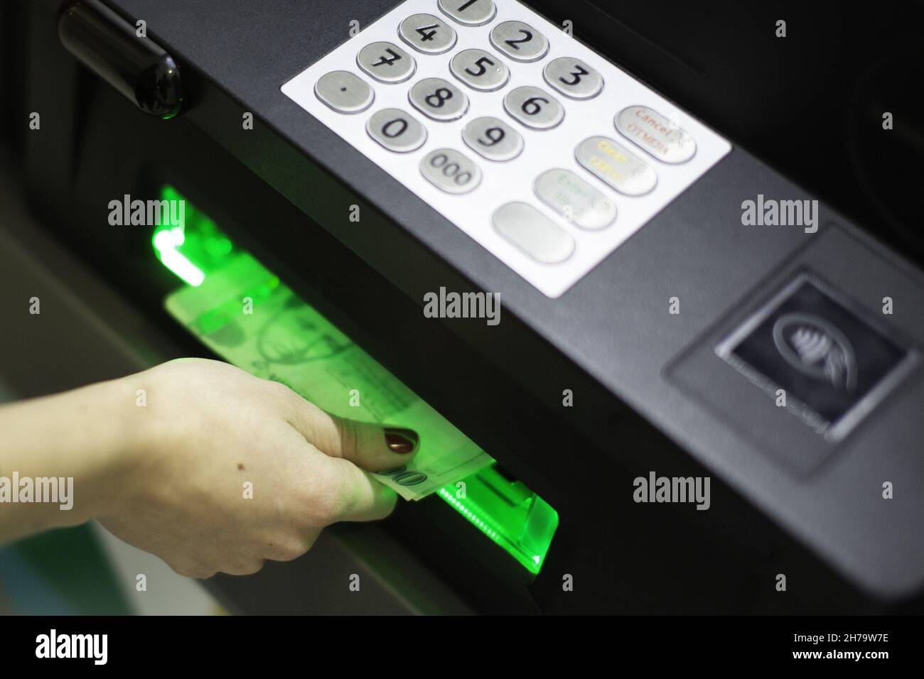 Receiving money from atm hi-res stock photography and images - Alamy