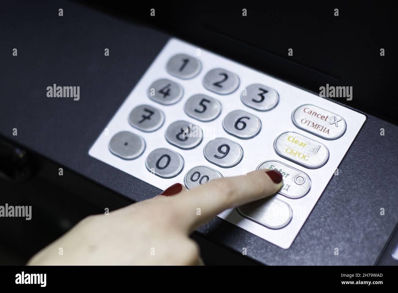 A female hand dialing a pin code at an ATM Stock Photo - Alamy