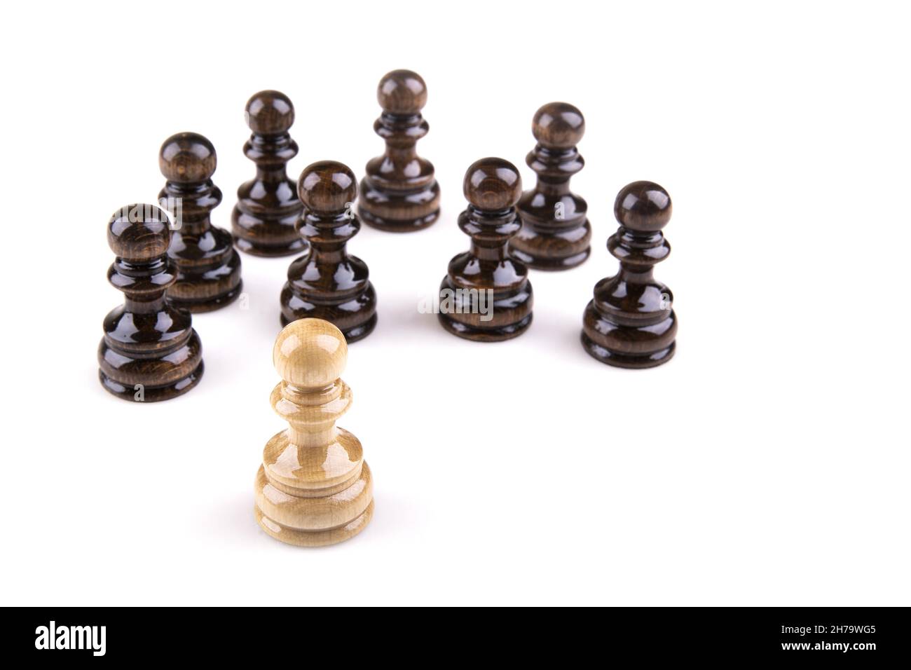 A single pawn against all black pawns isolated on white background ...