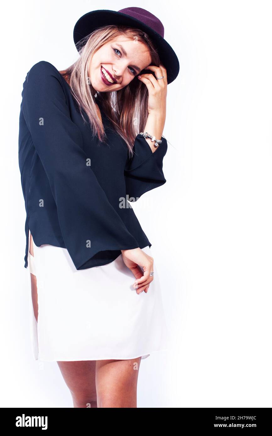 young pretty brunette girl hipster in hat on white background casual emotional posing smiling ...