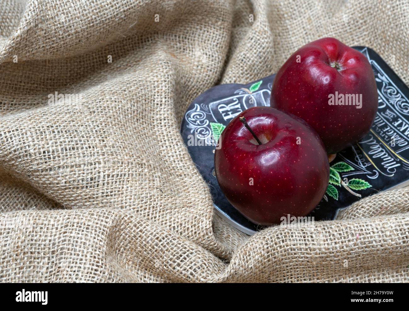 Two red juicy apples on a coarse linen fabric Stock Photo - Alamy