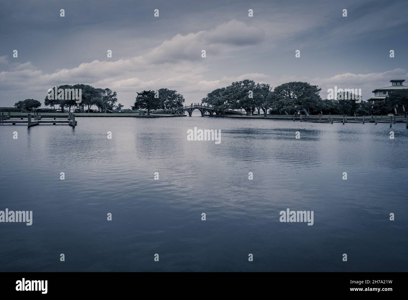 A minimalist and cinematic wide angle landscape photo of a pond in ...