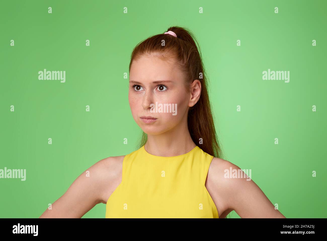 sad teen girl on green background. Human emotions Stock Photo - Alamy