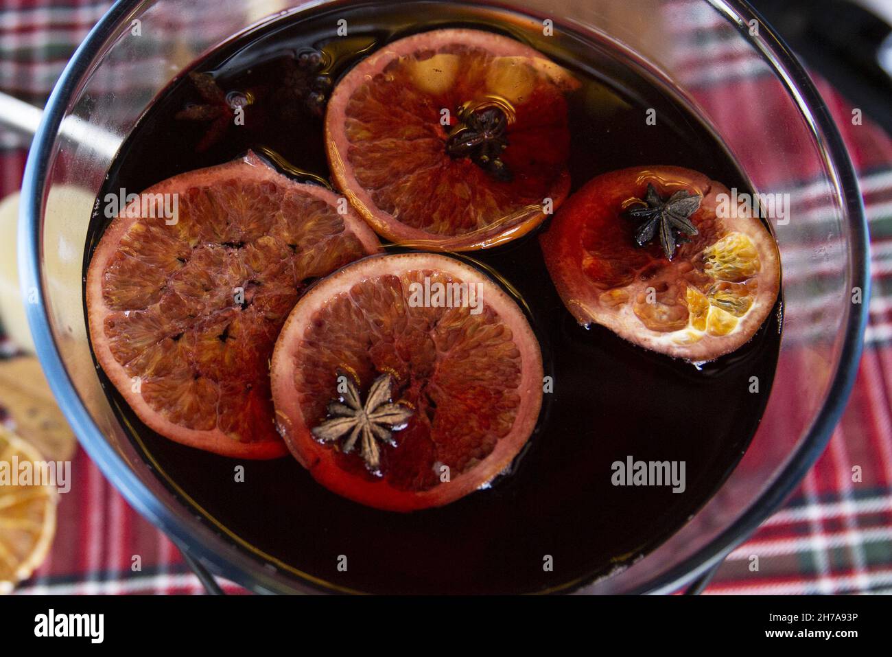 A glass of mulled wine with sliced oranges and star anise Stock Photo ...