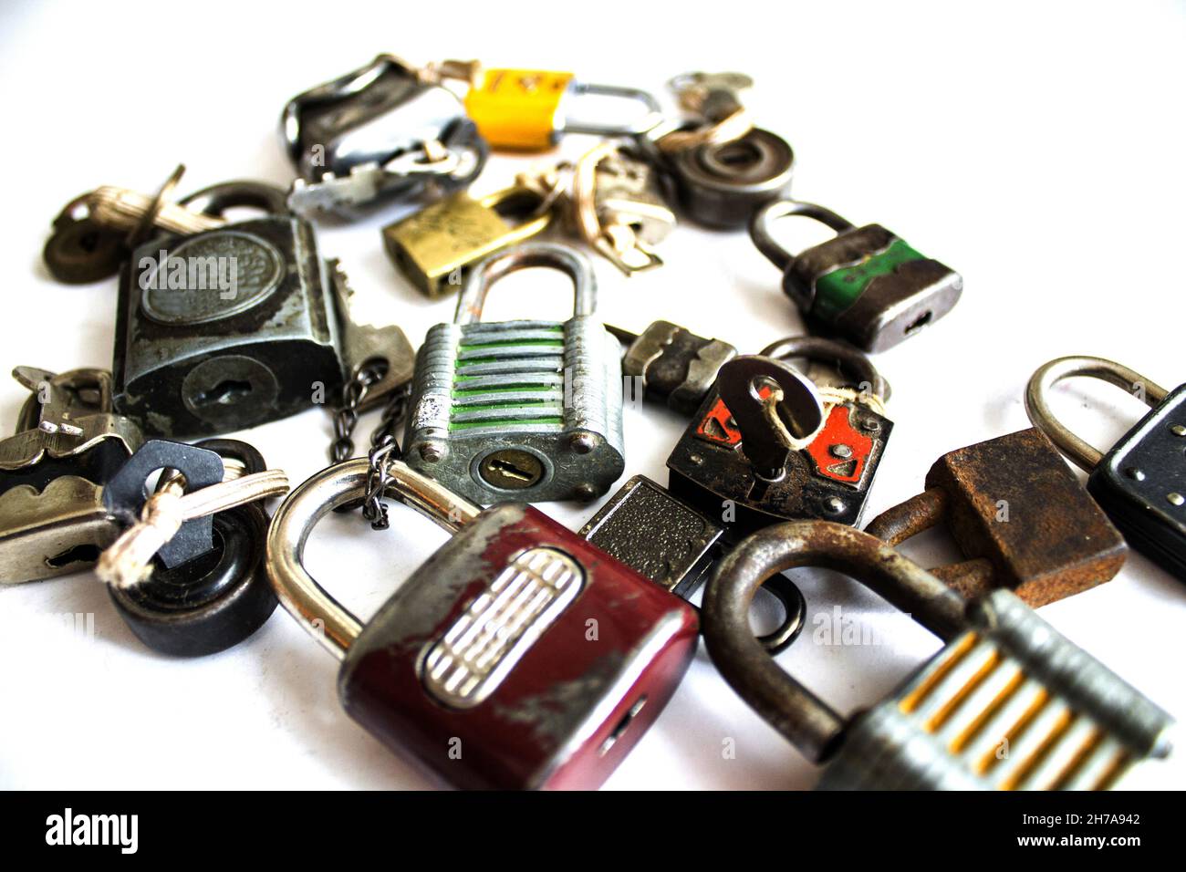 A pile of different metal padlocks on a white background Stock Photo ...