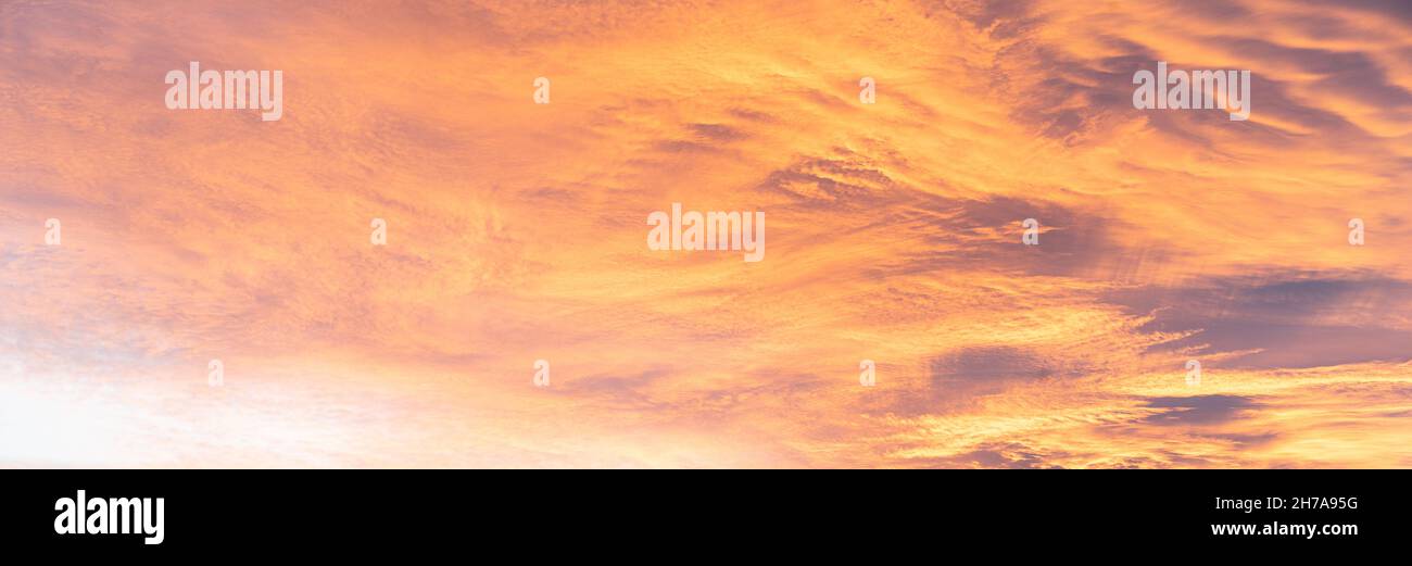 Cumulus sunset clouds with sun setting down Stock Photo - Alamy