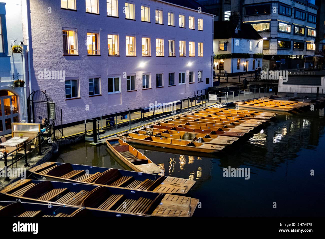 Traditional wooden punts moored up outside The Anchor Pub in the city ...