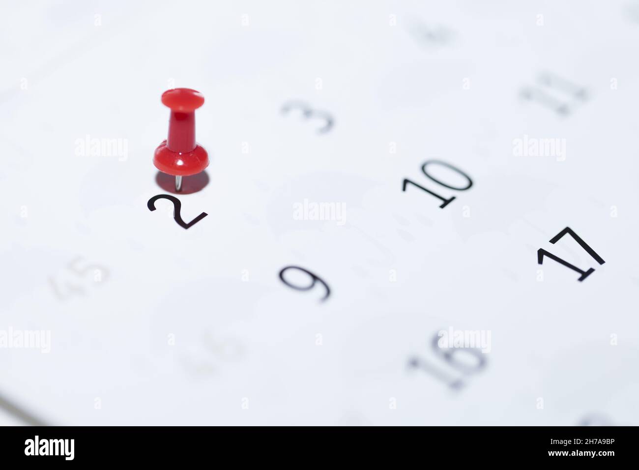 A red push pin on the 2nd day of the month on a calendar Stock Photo ...