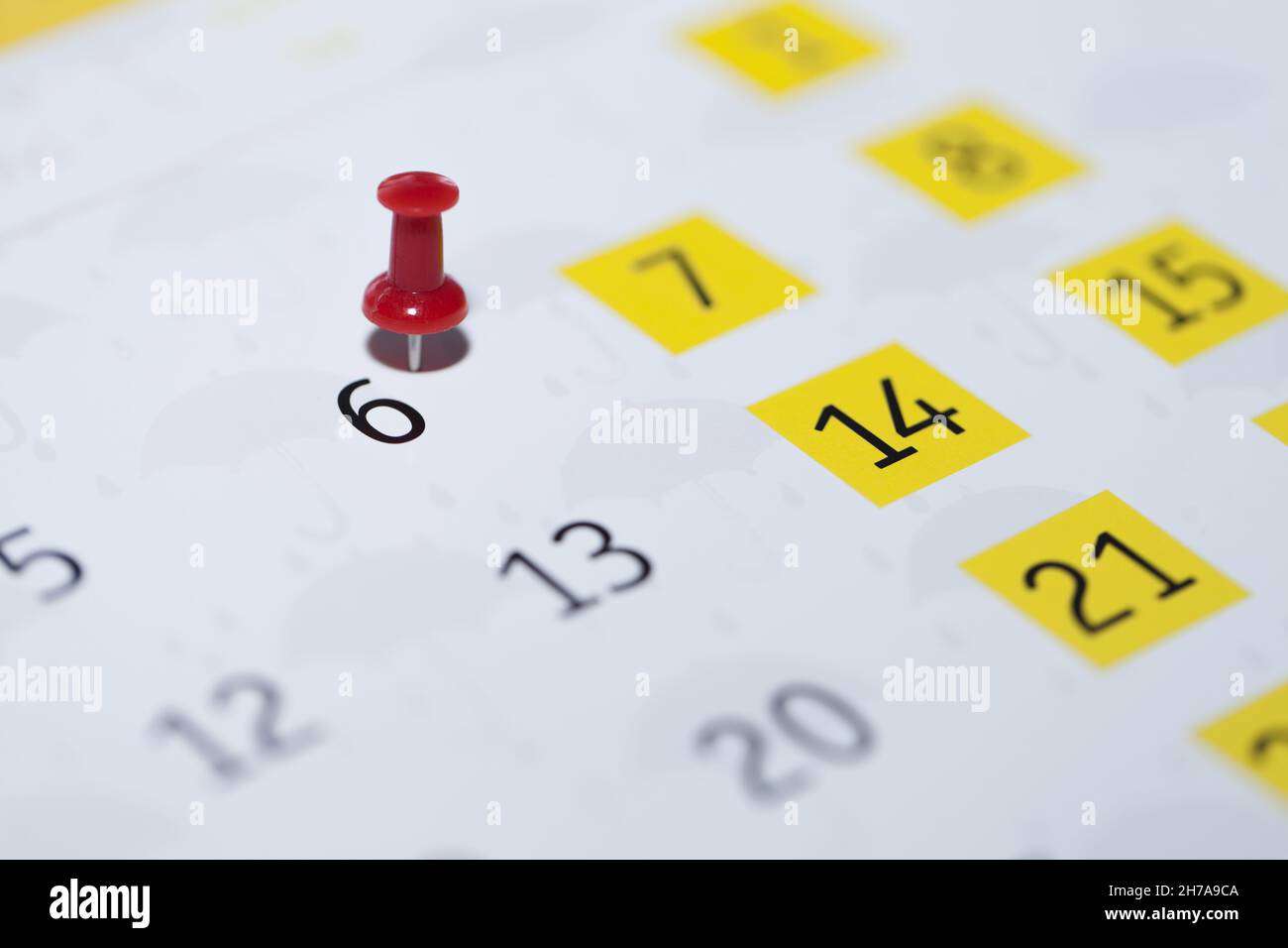 A red push pin on the 6th day of the month on a calendar Stock Photo ...