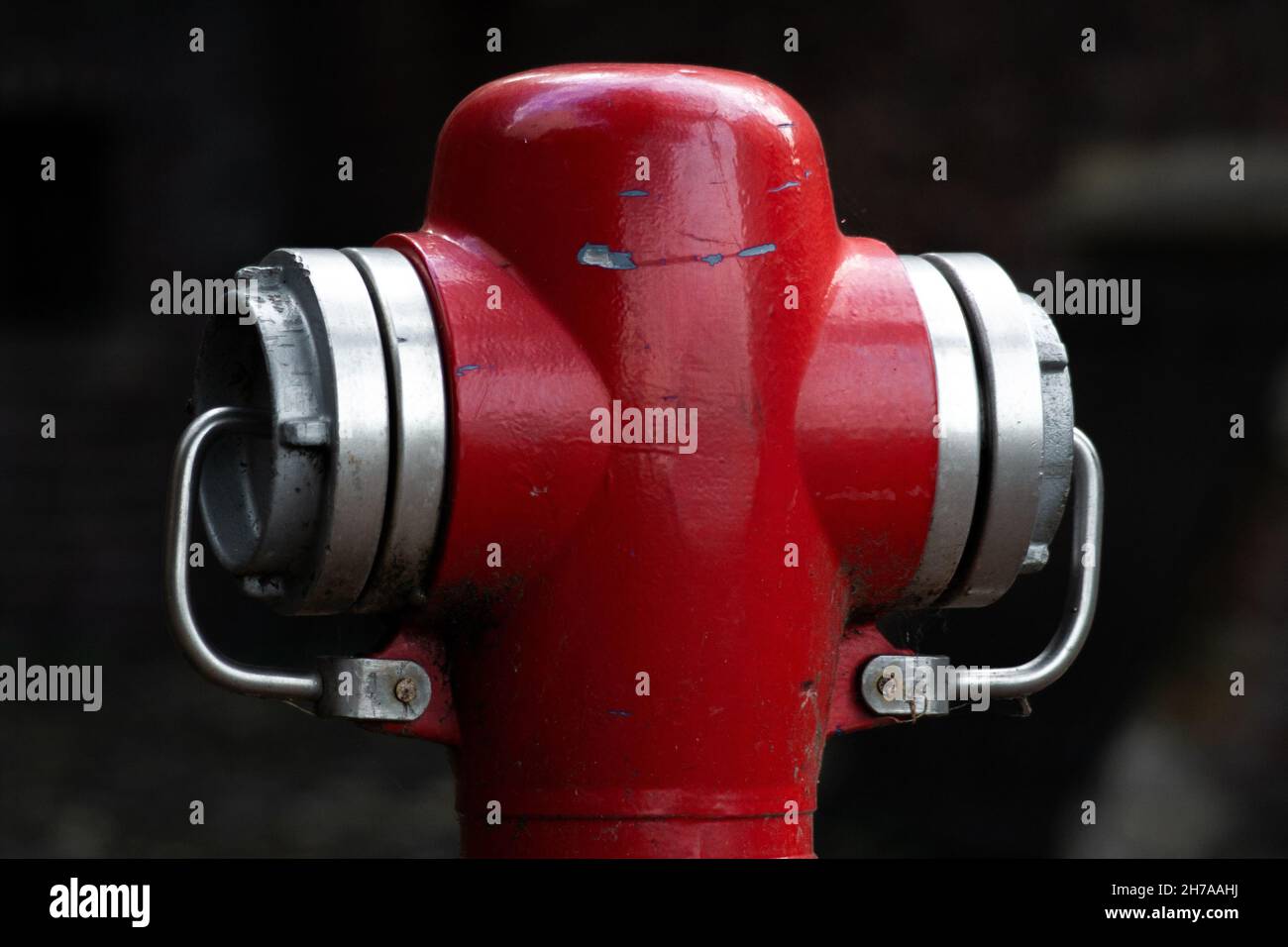 A close-up shot of an old weathered red fire hydrant placed on the ...