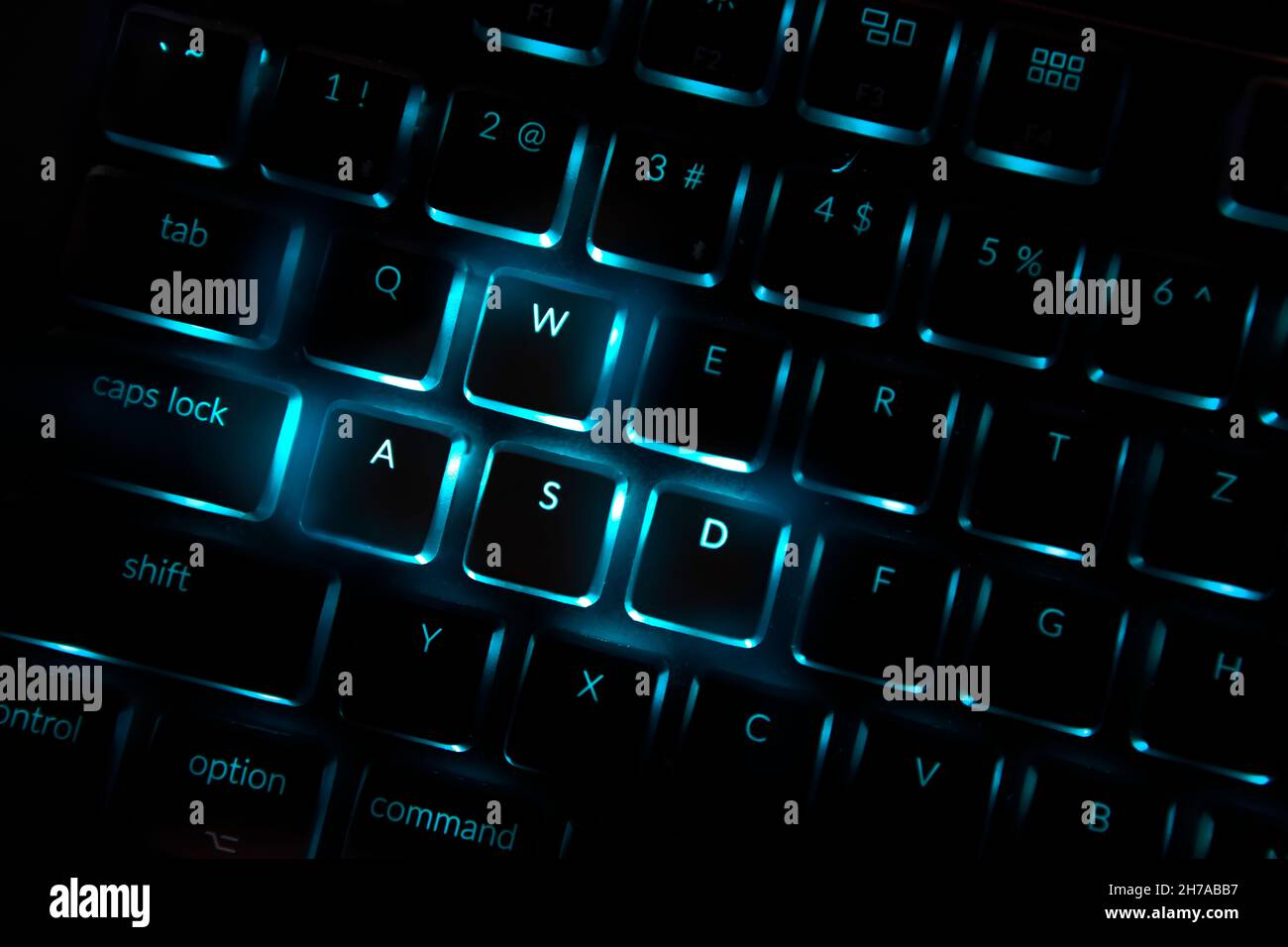 Blue color backlighted computer keyboard. Close-up of highlighted ...