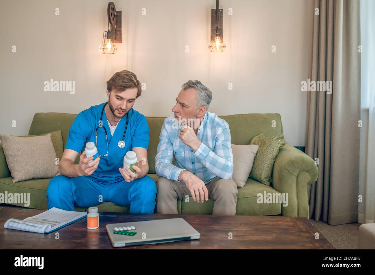 Qualified doctor explaining to patient how to choose dietary ...