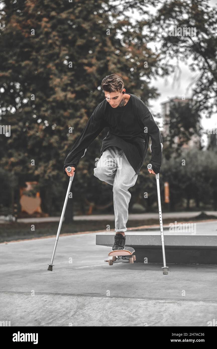 Disabled guy jumping on skateboard from springboard Stock Photo - Alamy