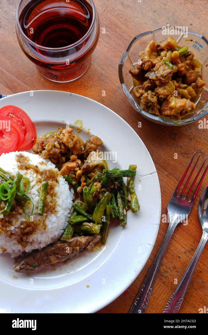 A vertical top view of Heavy food made of rice peanuts and meat with a ...