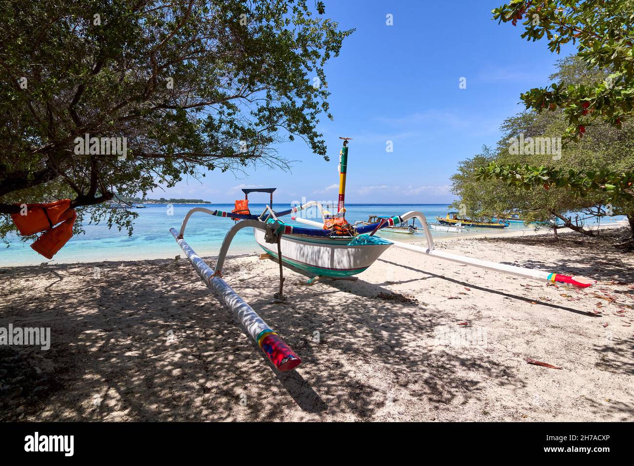 Traditional wooden boat on beautiful tropical beach at sunny morning ...