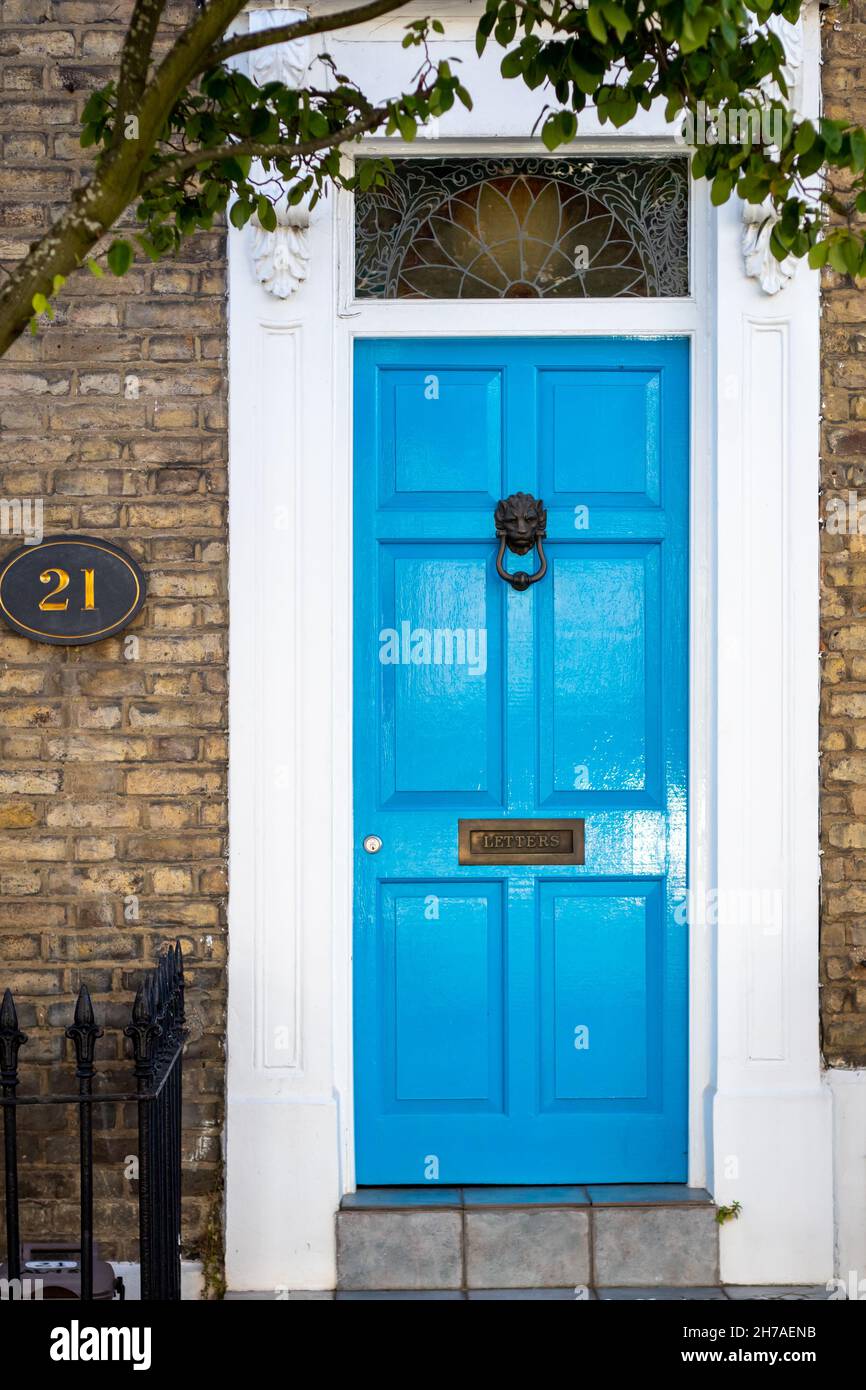 Traditional British front door in blue with the number 21 Stock Photo ...