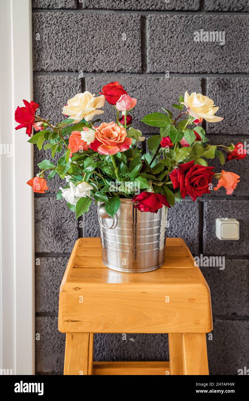A bucket with a freshly cut bouquet of roses in the interior of an ...