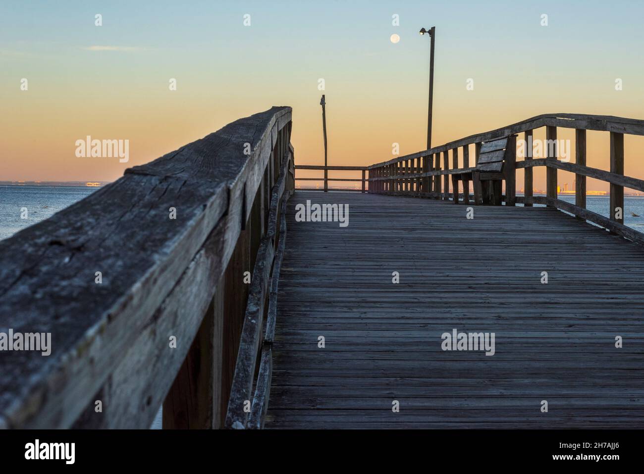 The moon sets over the pier at Bayfront Park in Daphne, Alabama Stock ...
