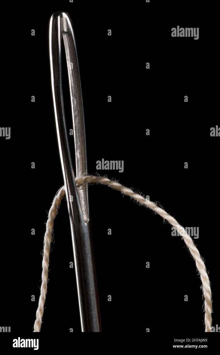 Sewing needle and thread, low key isolated Stock Photo - Alamy