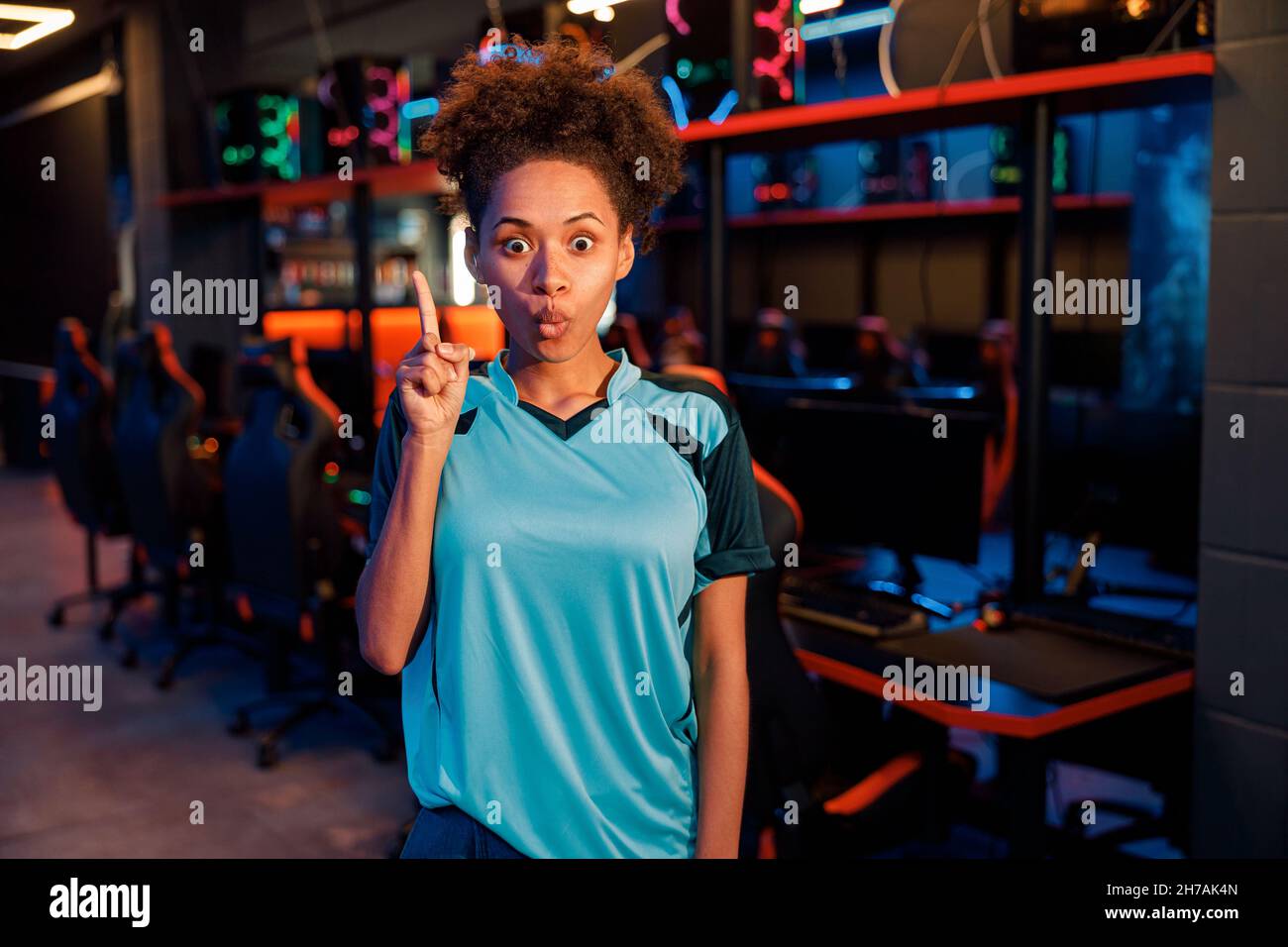 Funny woman gamer standing in room of gaming club Stock Photo - Alamy
