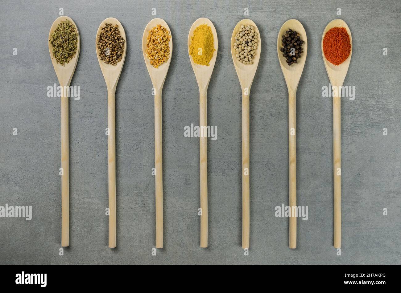 Various spices in wooden spoons side by side seen from above Stock ...