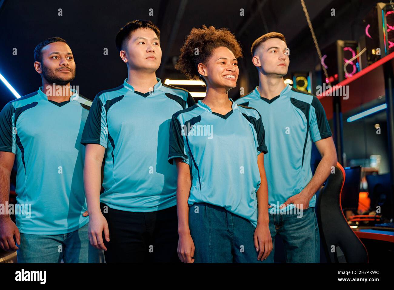 Multiethnic esports team posing at camera in cyber club Stock Photo - Alamy