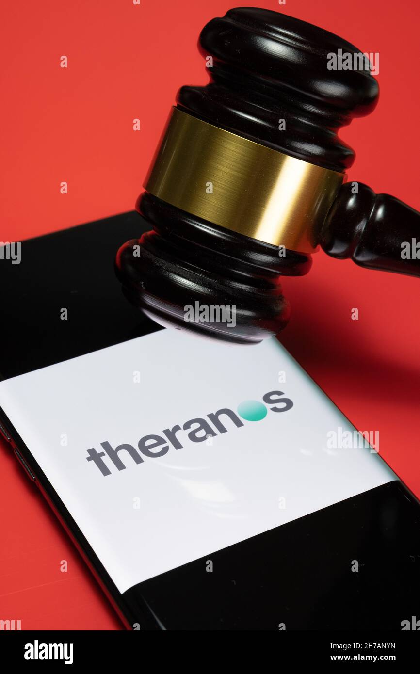 Theranos company logo seen on smartphone screen and judges gavel above ...