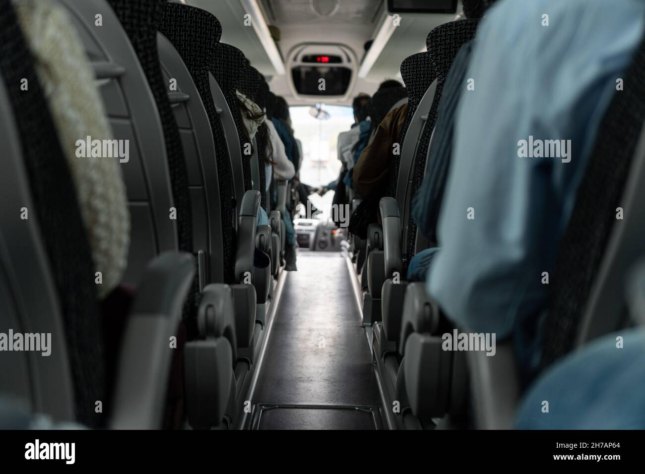 View of two rows of double seats in a travel bus with passengers Stock ...