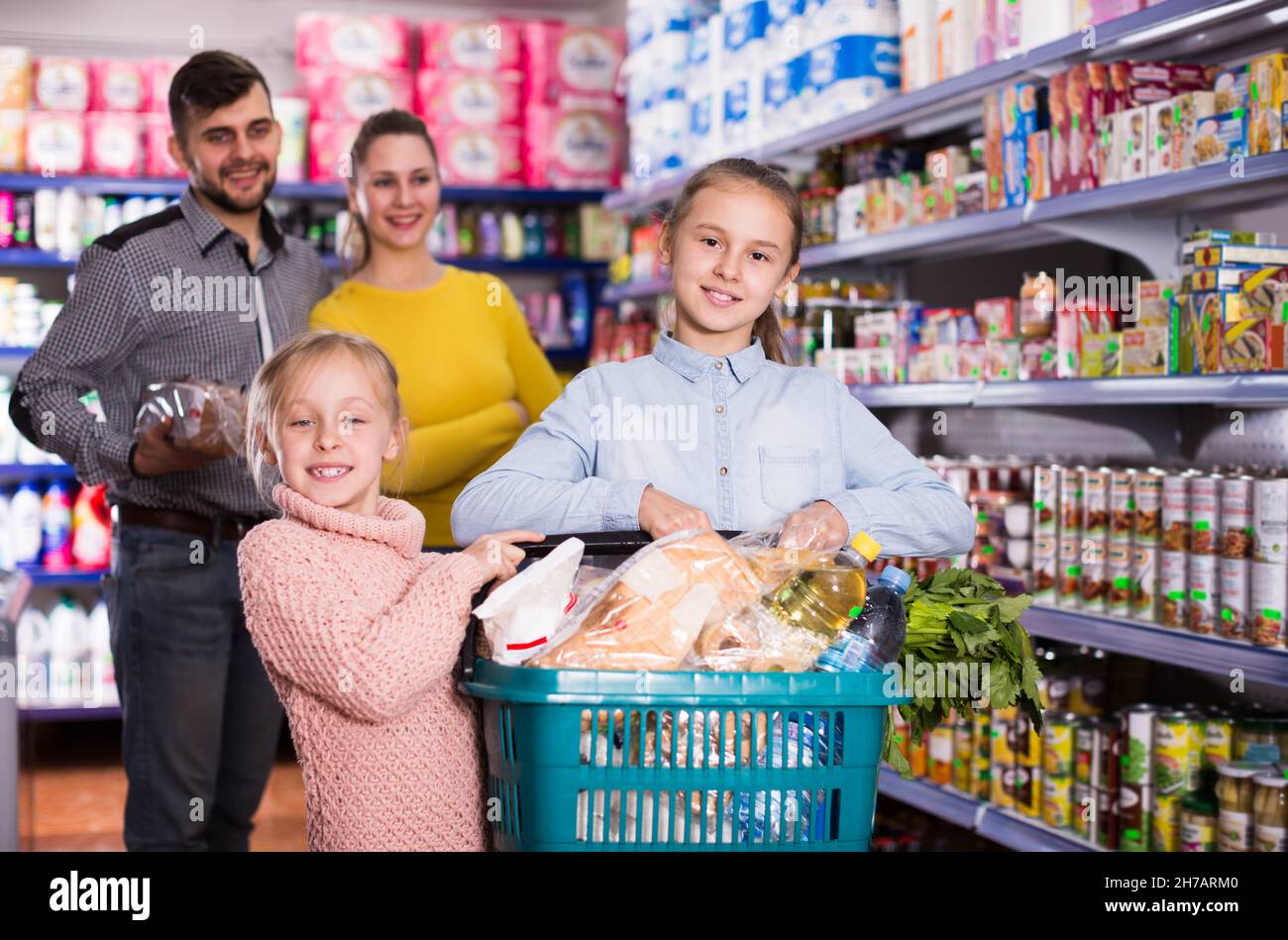 kids holding basket filled products Stock Photo - Alamy