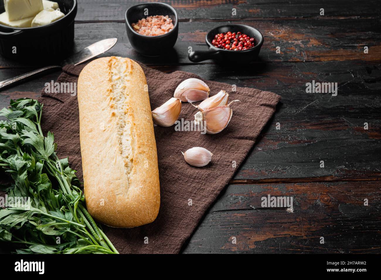 Garlic bread compound butter and herb ingredients set, on old dark ...