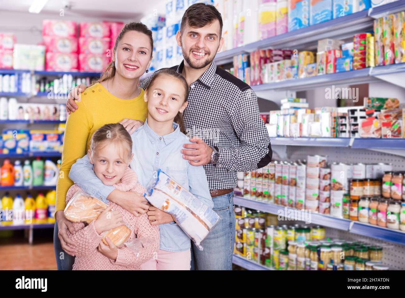 Portrait of family with daughters in food store Stock Photo - Alamy