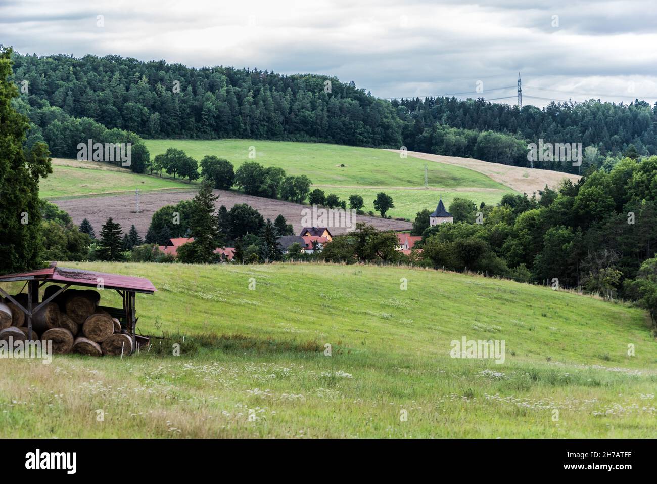 Village view over farmland, hills and meadows at the German countryside ...