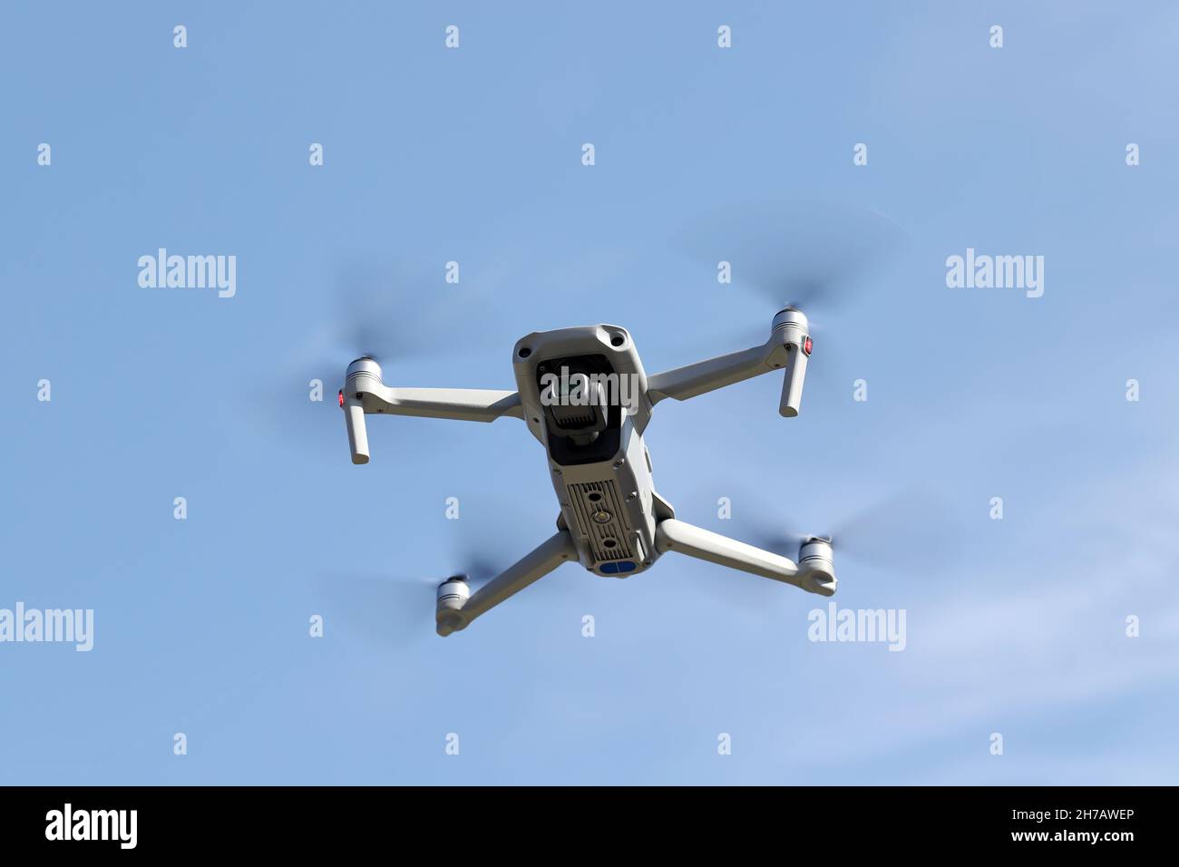 Drone flying in air and clear blue sky background Stock Photo - Alamy