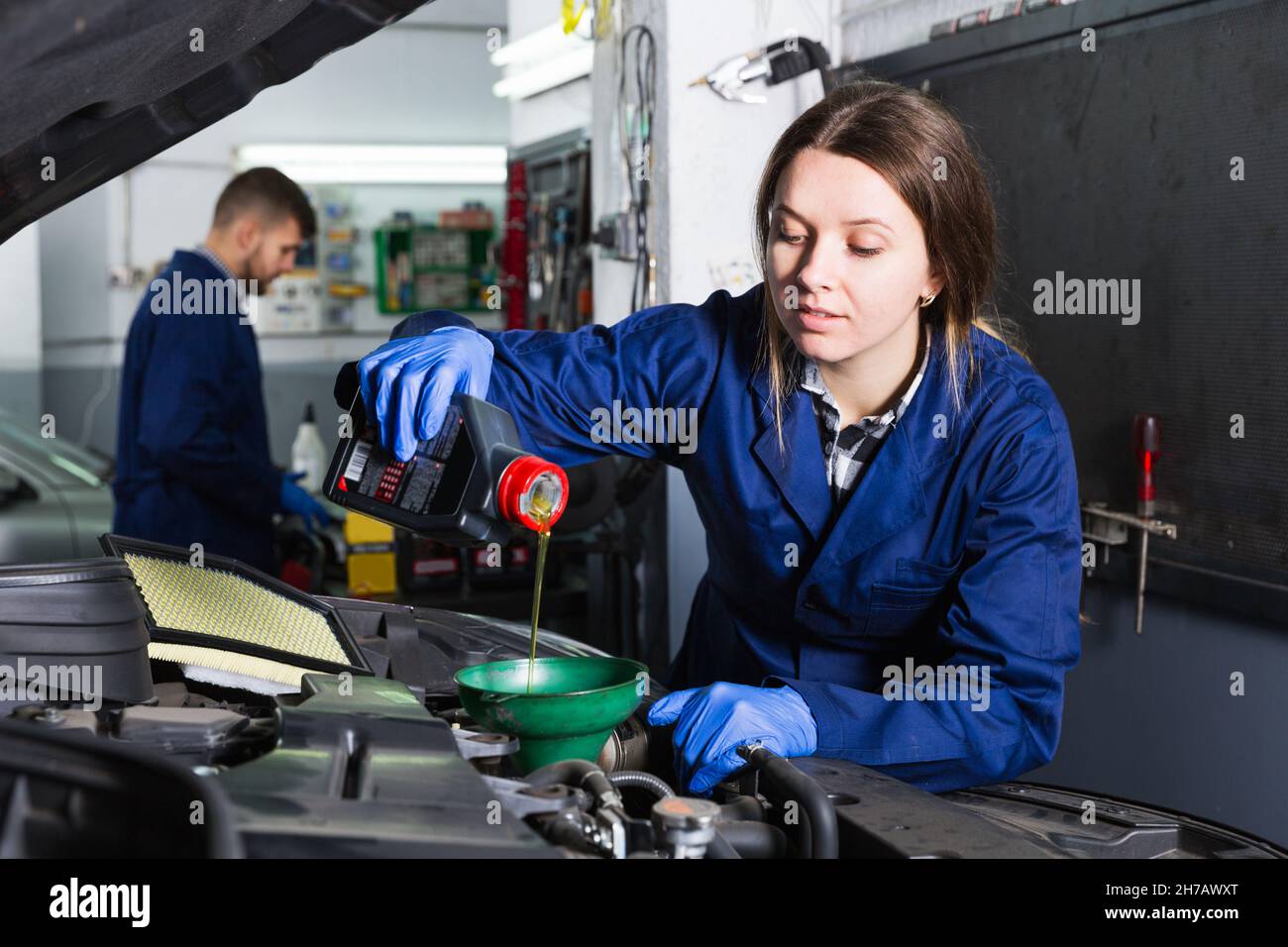 Female is replacing the oil Stock Photo - Alamy