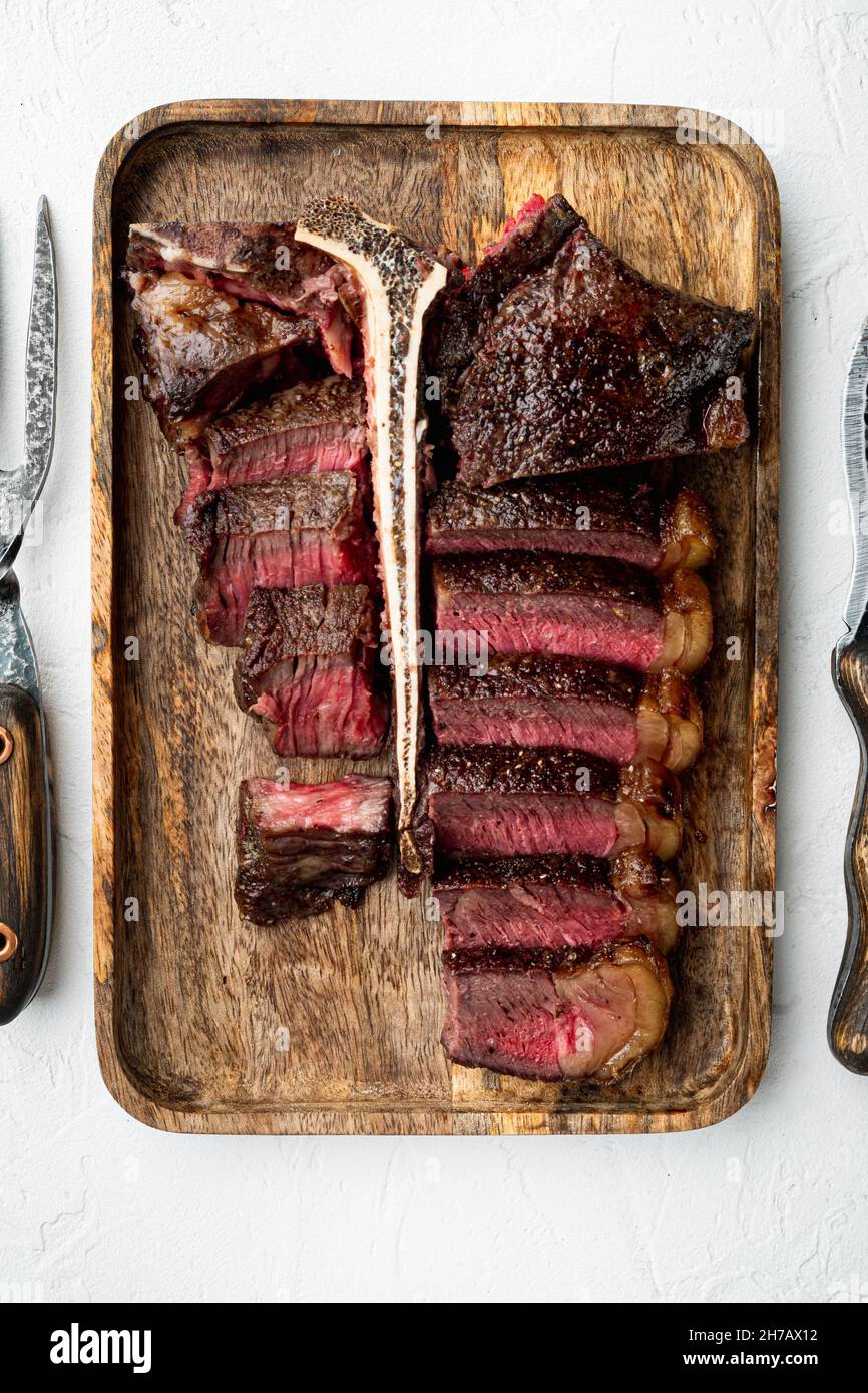 Porterhouse steak is grilled sliced on a piece set, on white stone ...