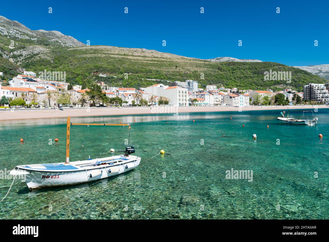 Petrovac beach and harbor, Montenegro. Boats, sand and holliday houses ...