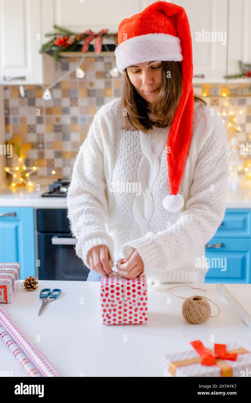 Woman santa claus packing present hi-res stock photography and images ...