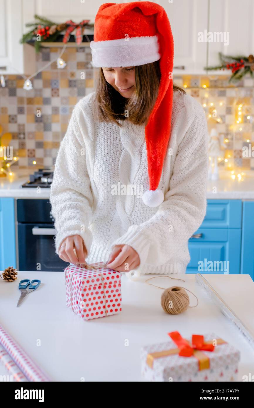 Woman santa claus packing present hi-res stock photography and images ...
