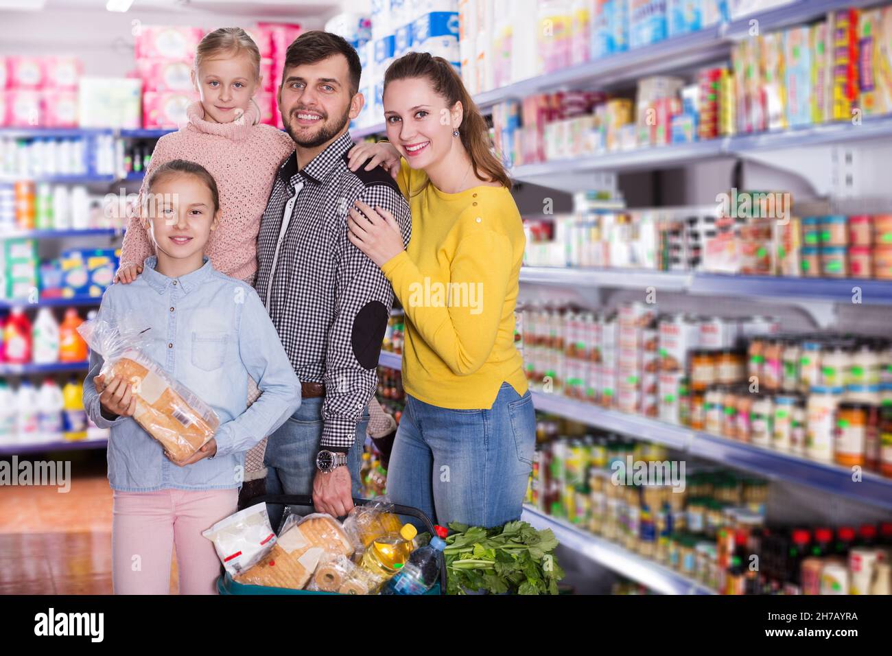 parents with girls with purchases during family shopping Stock Photo ...