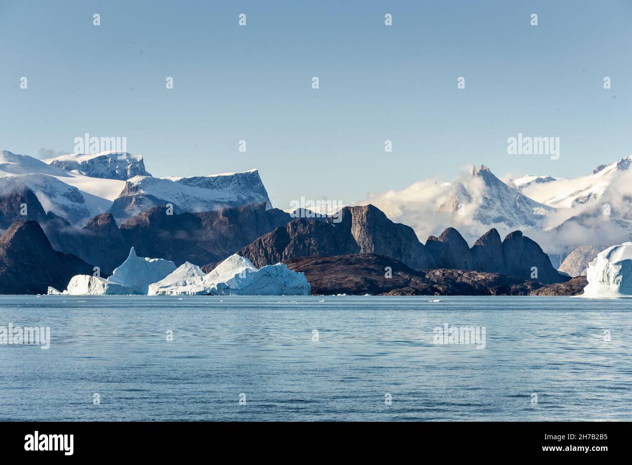 Icebergs and igneous rock bornhardts, Jameson Land, Scoresby Sund ...