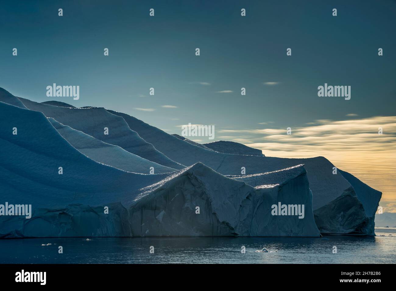 Backlit iceberg at sunset, Hall Bredning, Scoresby Sund, Greenland ...
