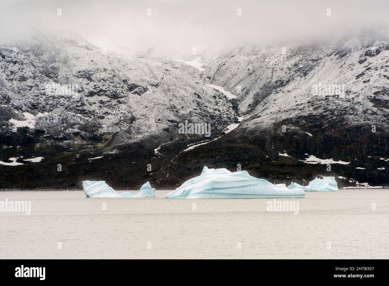 Snow covered Geikie Plateau and blue iceberg, Denmark Island, near ...